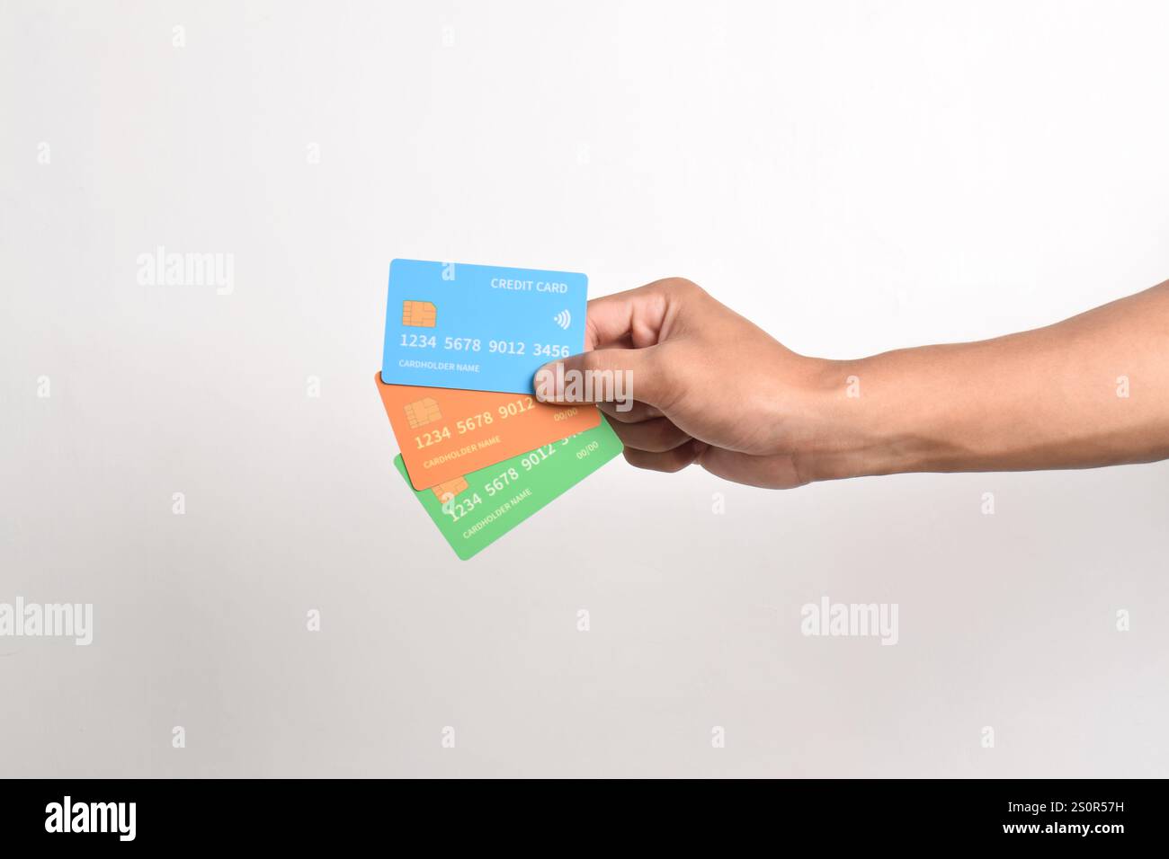 Hand is hold three credit cards. Blue, green and orange credit cards ...