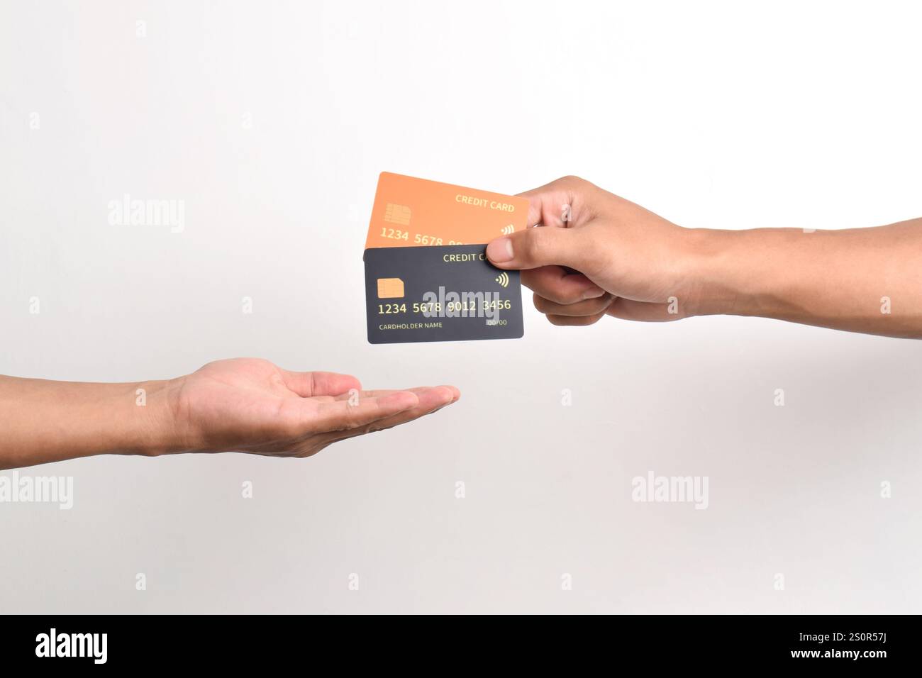 Hand holding two credit cards and other hand receiving isolated on ...