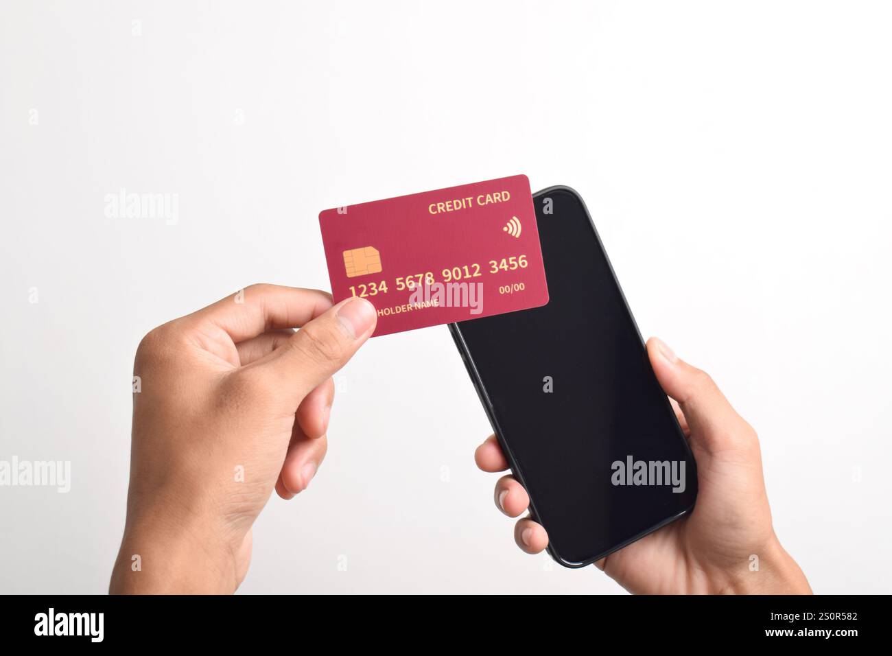 Male hands holding mobile phone and credit card isolated on white ...