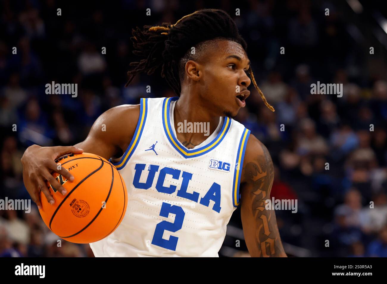 UCLA's Dylan Andrews dribbles during the first half of an NCAA college ...