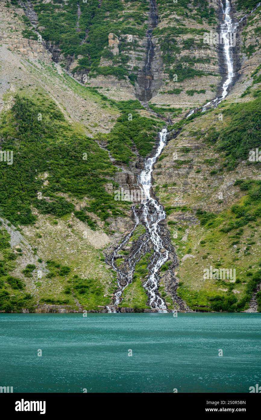 Waterfall From Dixon Glacier Flows Into The Blue Green Water Of Lake ...