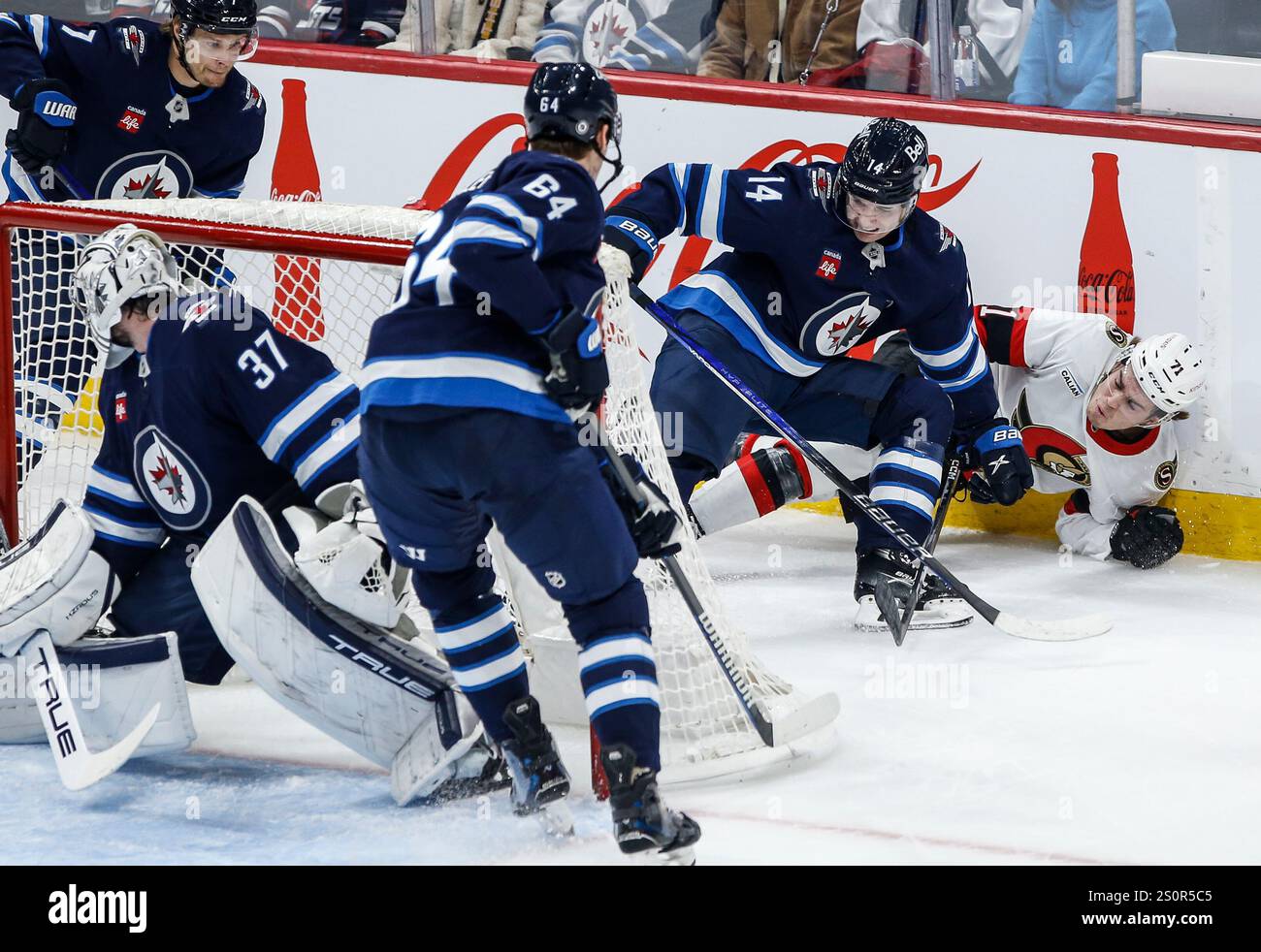 Winnipeg Jets' Ville Heinola (14) and Ottawa Senators' Ridley Greig (71 ...