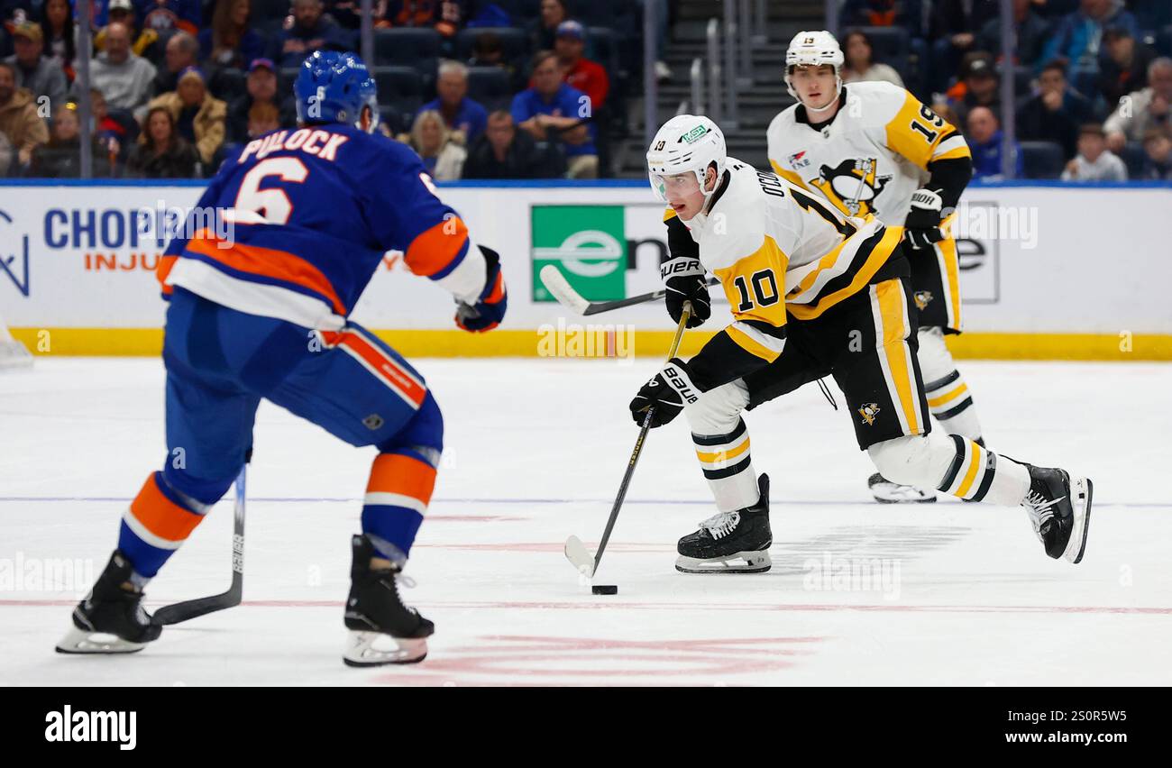 Pittsburgh Penguins left wing Drew O'Connor (10) skates with the puck ...