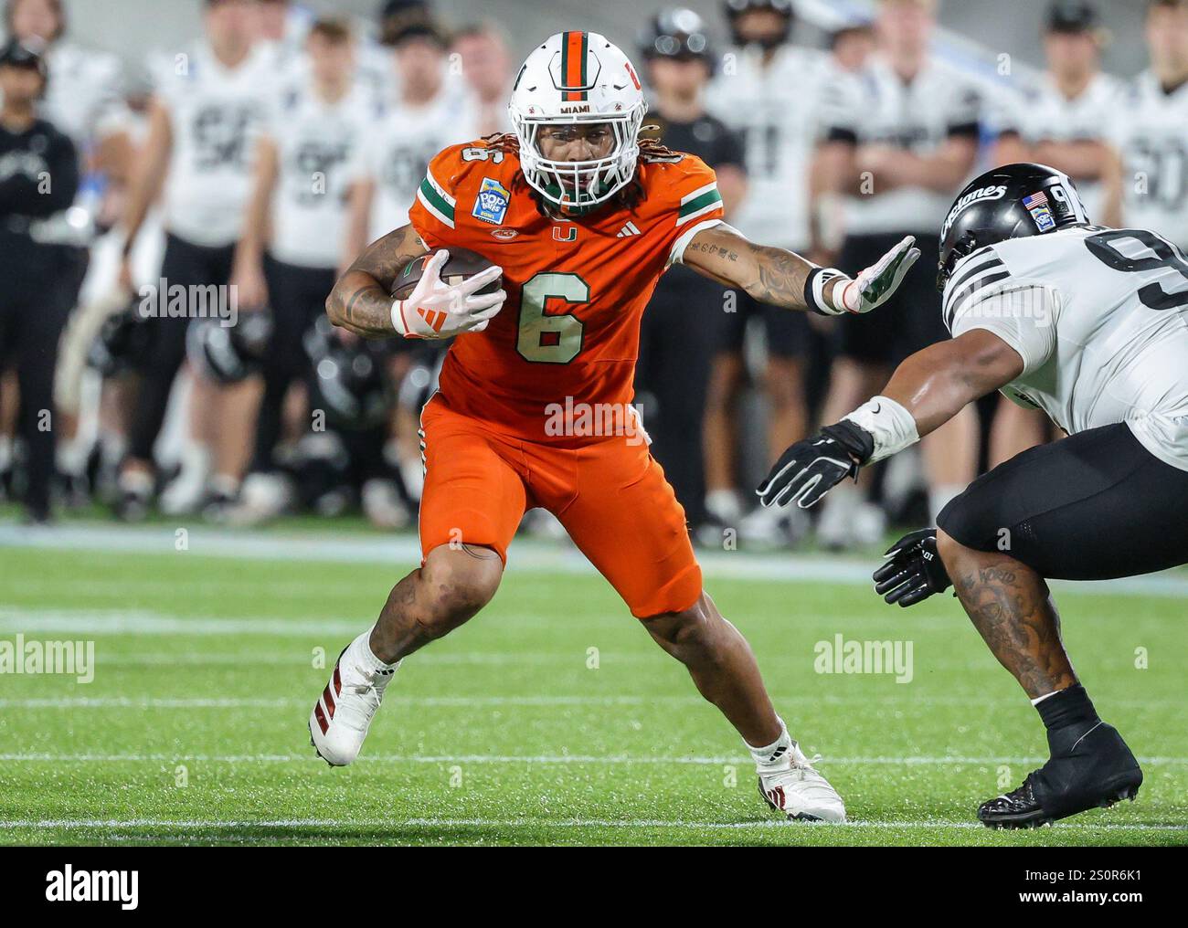 Orlando, FL, USA. 28th Dec, 2024. Miami RB Damien Martinez (6) makes a ...