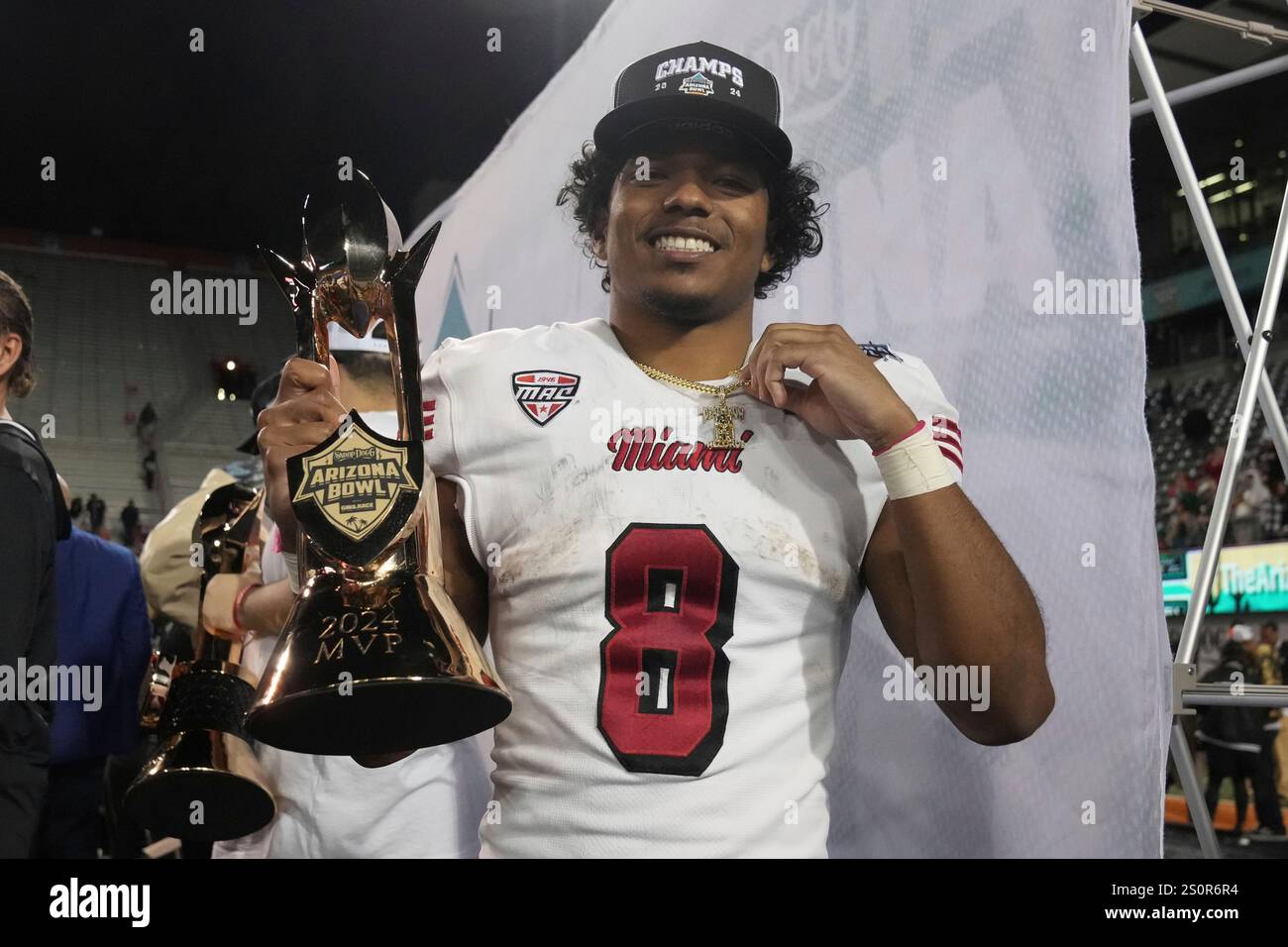 Miami (Ohio) running back Kevin Davis (8) poses with the MVP trophy ...