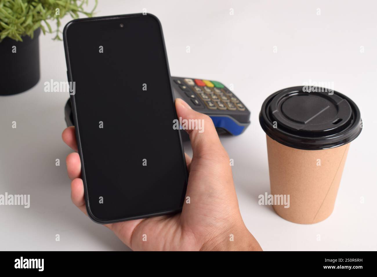 Hand holding smartphone for payment in Payment terminal. Mobile payment ...