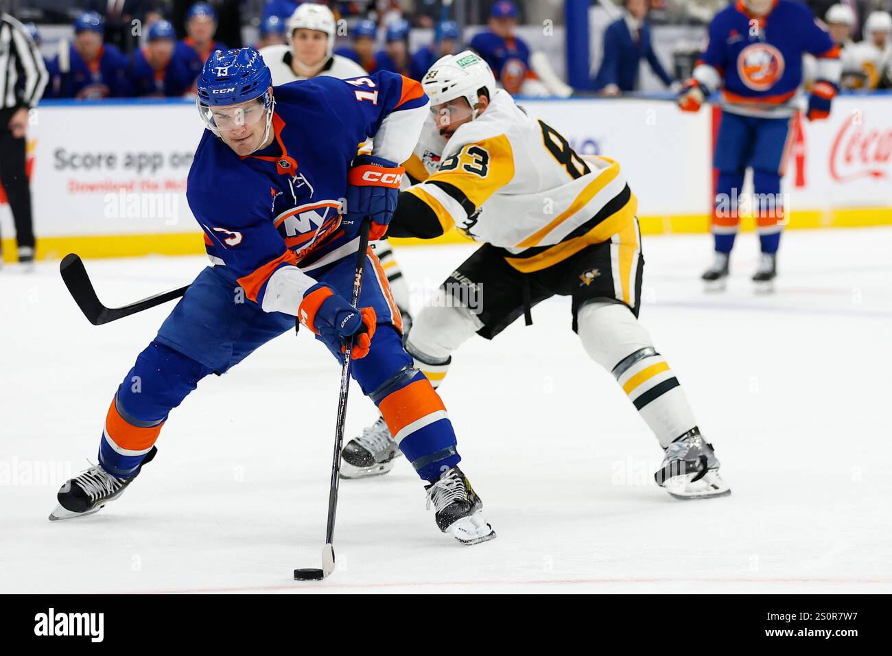 New York Islanders center Mathew Barzal (13) plays the puck against ...