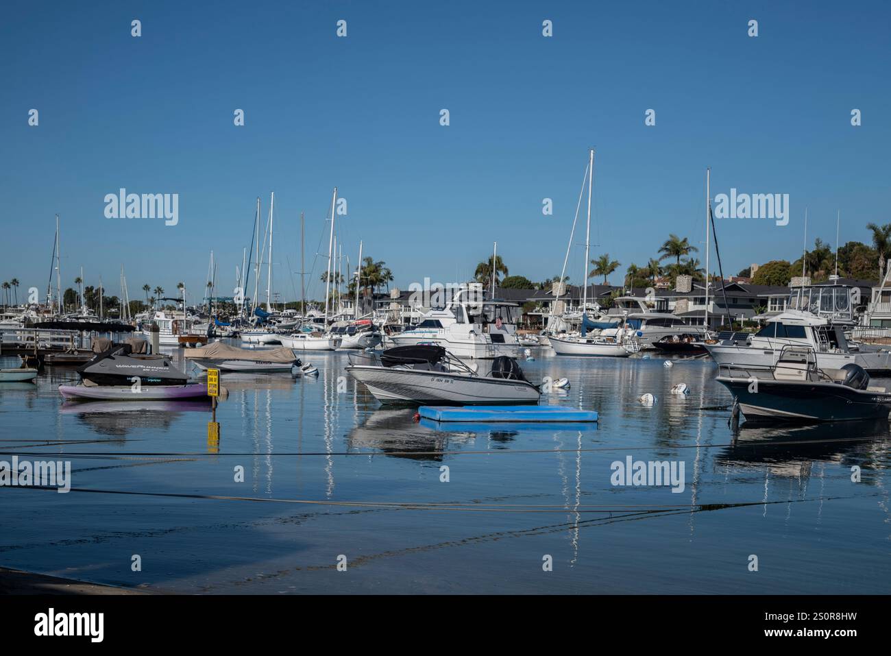 Boats on the harbor gently sway in the water, creating a serene and ...