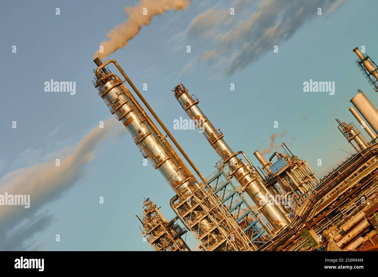 View of a chemical plant featuring a distillation column and emissions ...