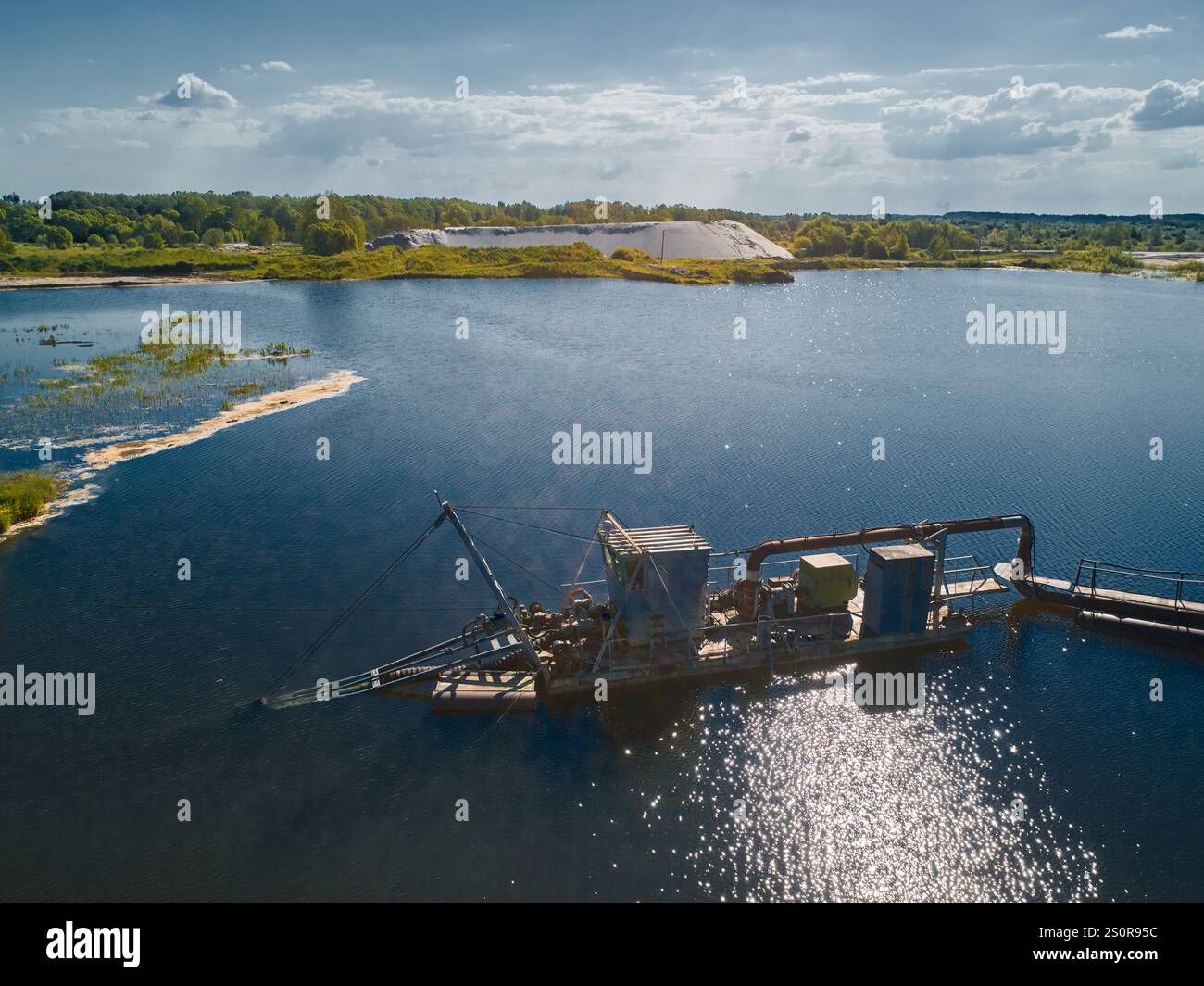 Suction dredger vessel works drawing up bottom mud on river Stock Photo ...