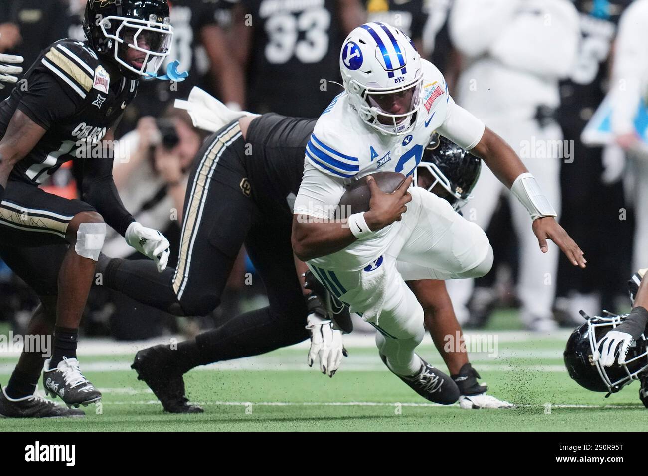 BYU quarterback Gerry Bohanon (3) is tripped up on a run against ...