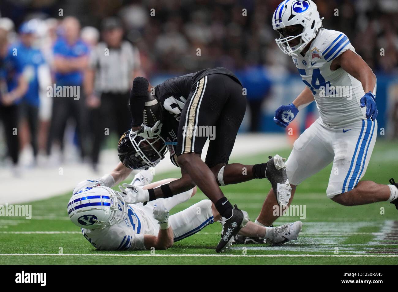 Colorado wide receiver Travis Hunter, top left, is upended by BYU ...