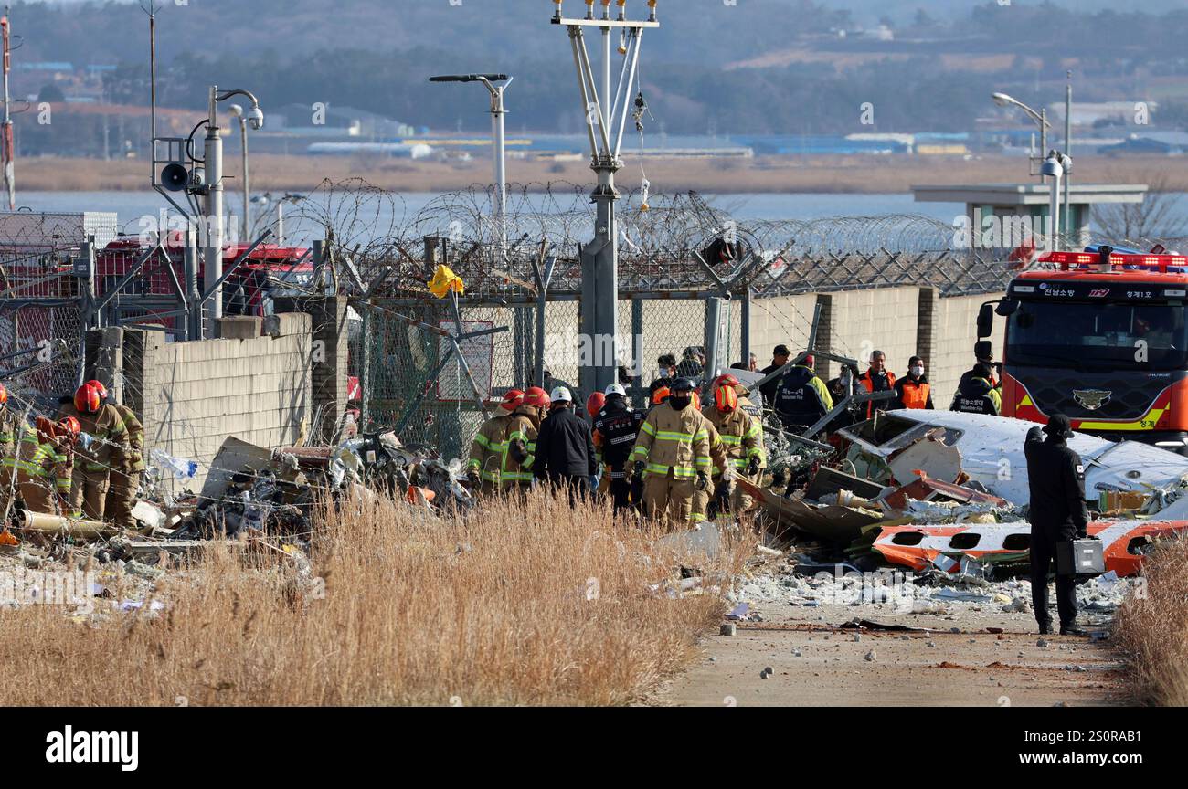 Firefighters and rescue team members work at Muan International Airport ...