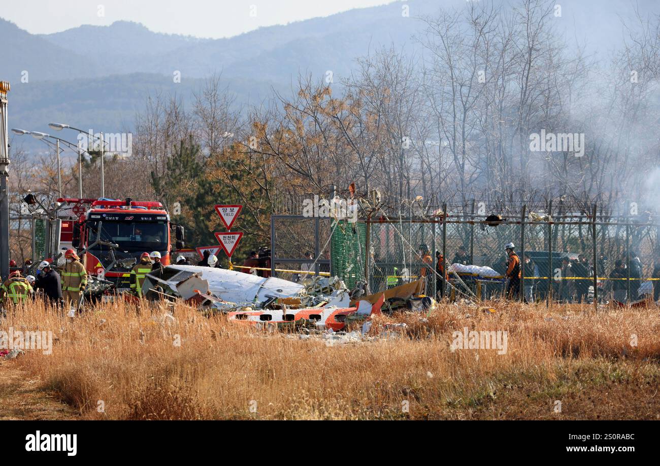 Firefighters and rescue team members work at Muan International Airport ...