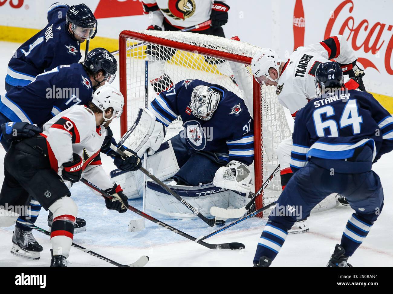 Winnipeg Jets goaltender Connor Hellebuyck (37) saves a shot as Ottawa ...