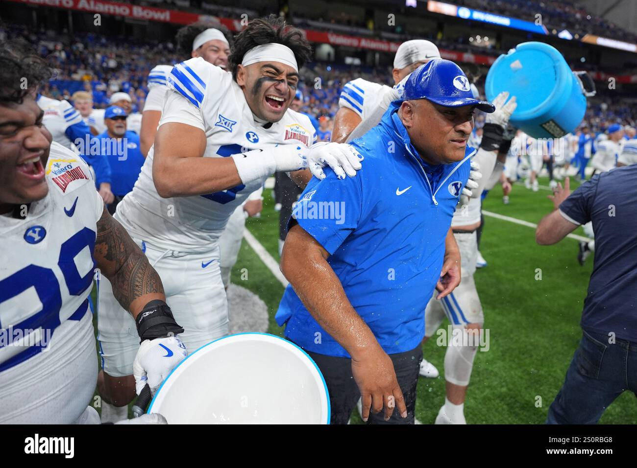 BYU head coach Kalani Sitake, center, reacts after being doused as he ...