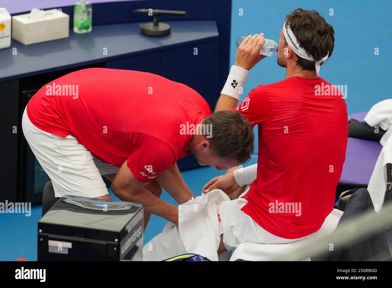 Norway's Casper Ruud receives treatment from his team captain Christian ...