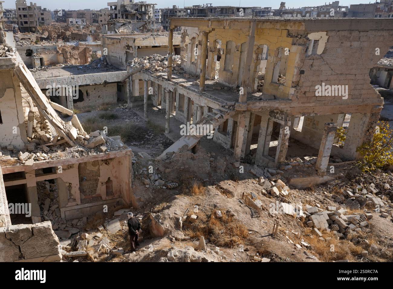 A Syrian man observes the destroyed Jobar Synagogue, also known as ...