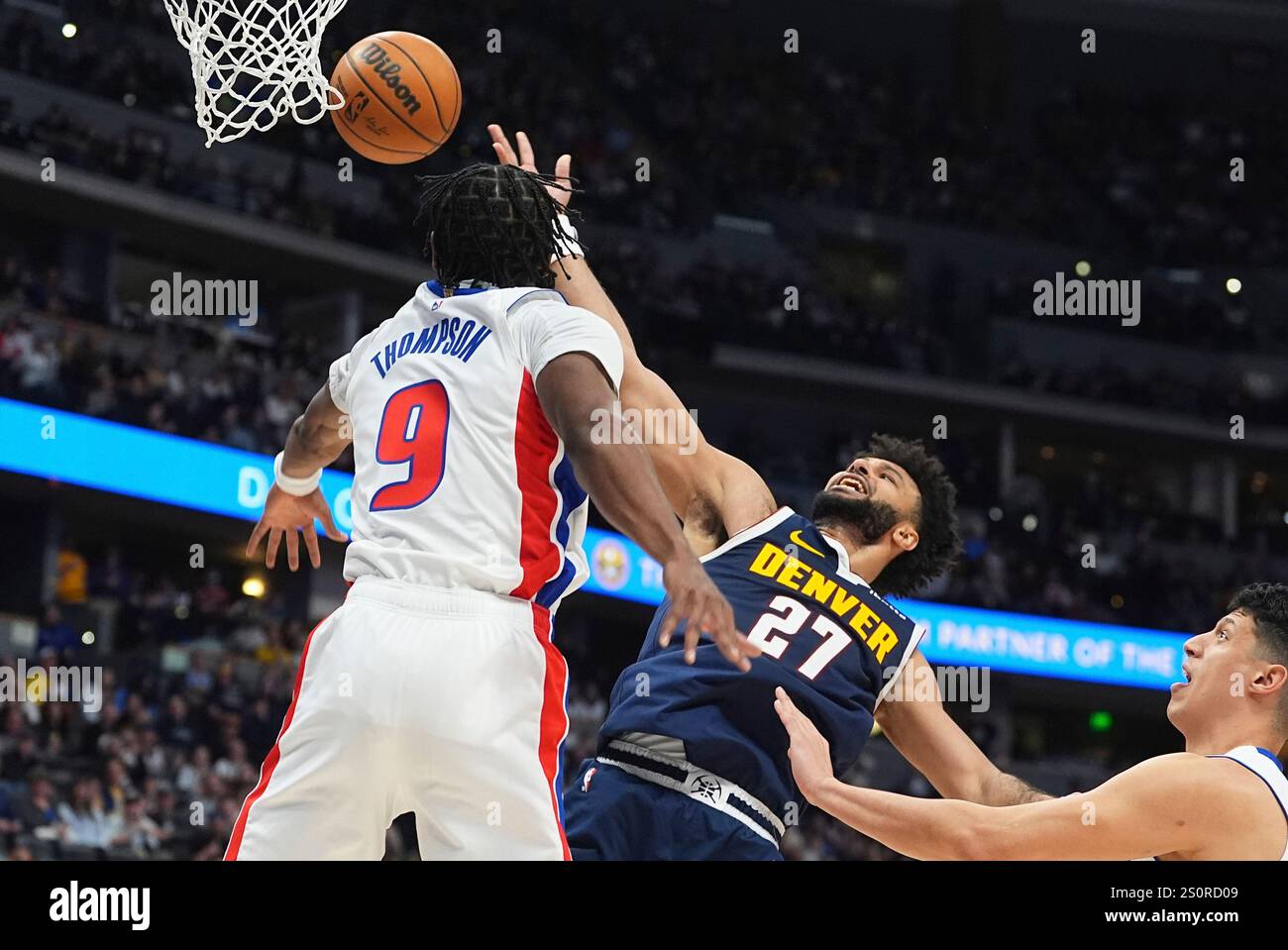 Denver Nuggets guard Jamal Murray, center, drives to the basket between ...