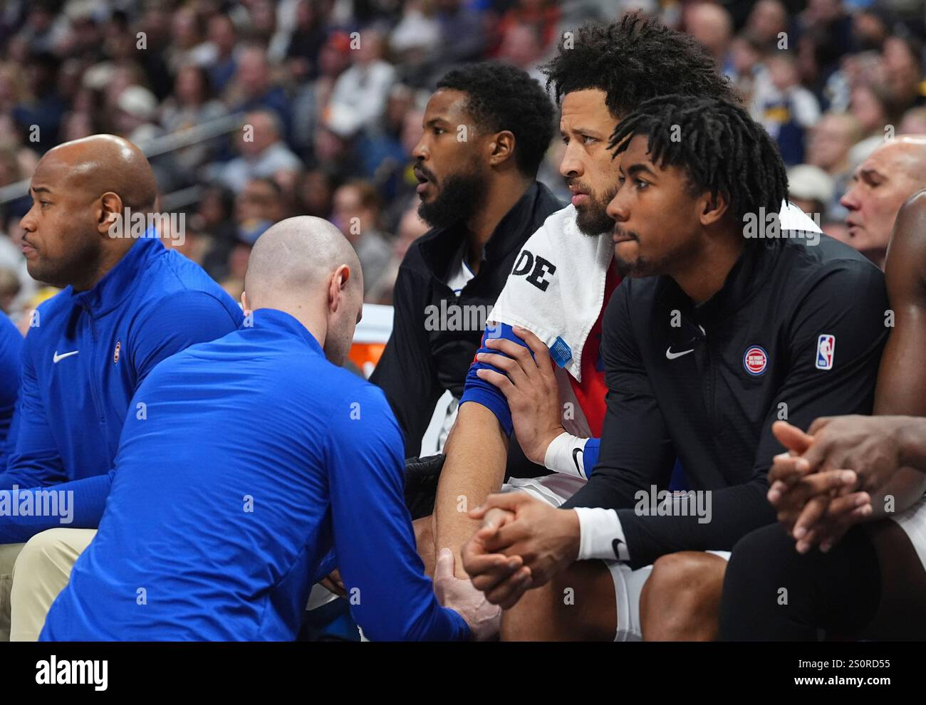 Detroit Pistons guard Cade Cunningham, center right, is tended to by ...
