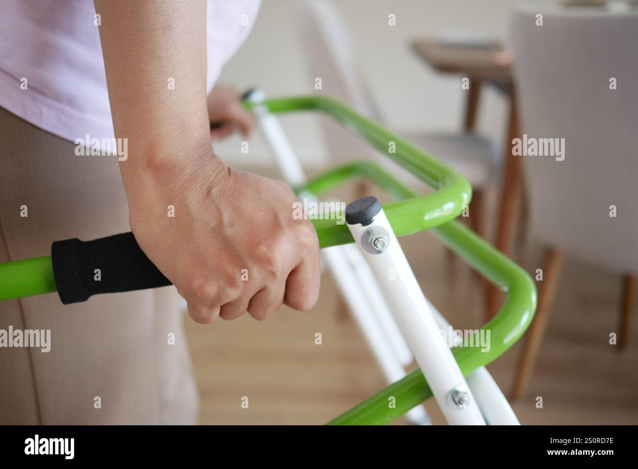 A Person Using a Modern Walker in a Bright and Welcoming Living Space ...