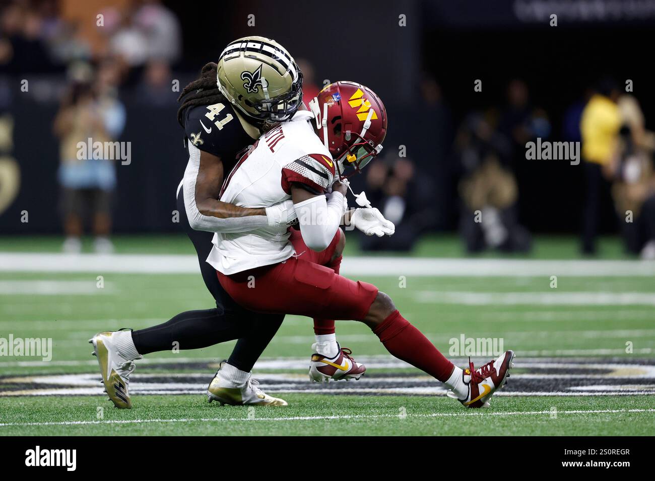 Washington Commanders cornerback Mike Sainristil (0) intercepts the ...