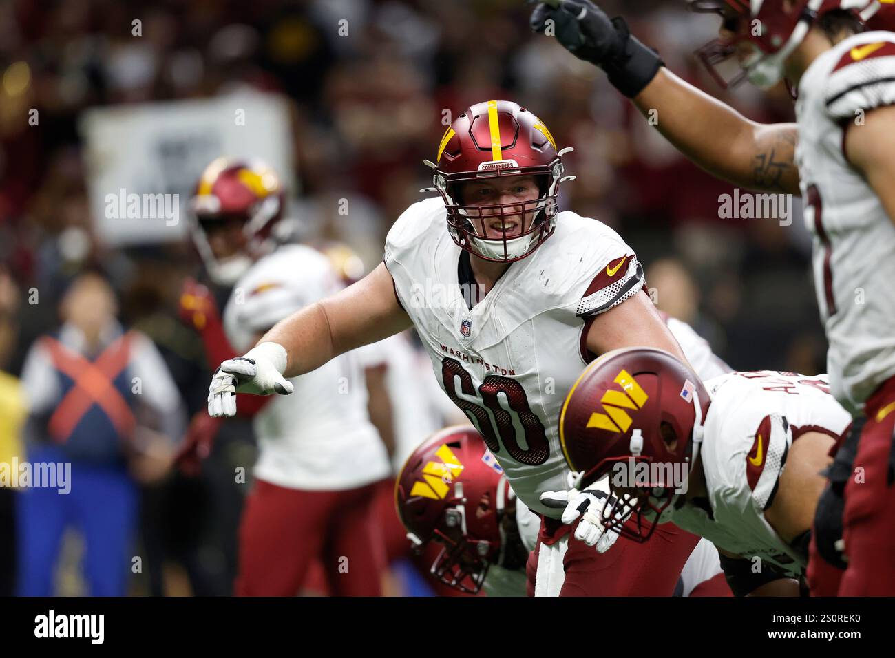 Washington Commanders guard Michael Deiter (60) calls a play during an ...