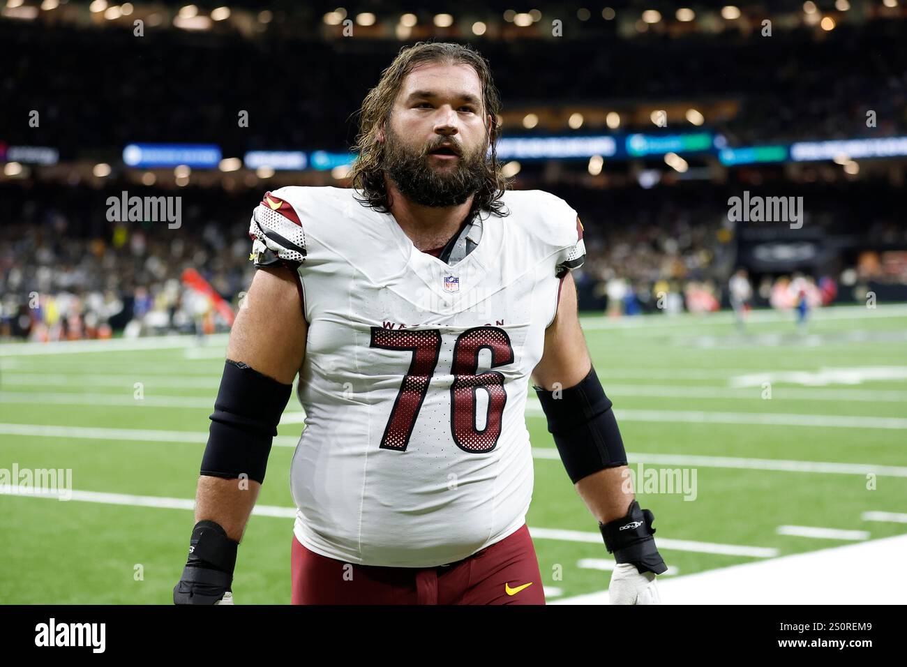 Washington Commanders guard Sam Cosmi (76) warms up before an NFL ...