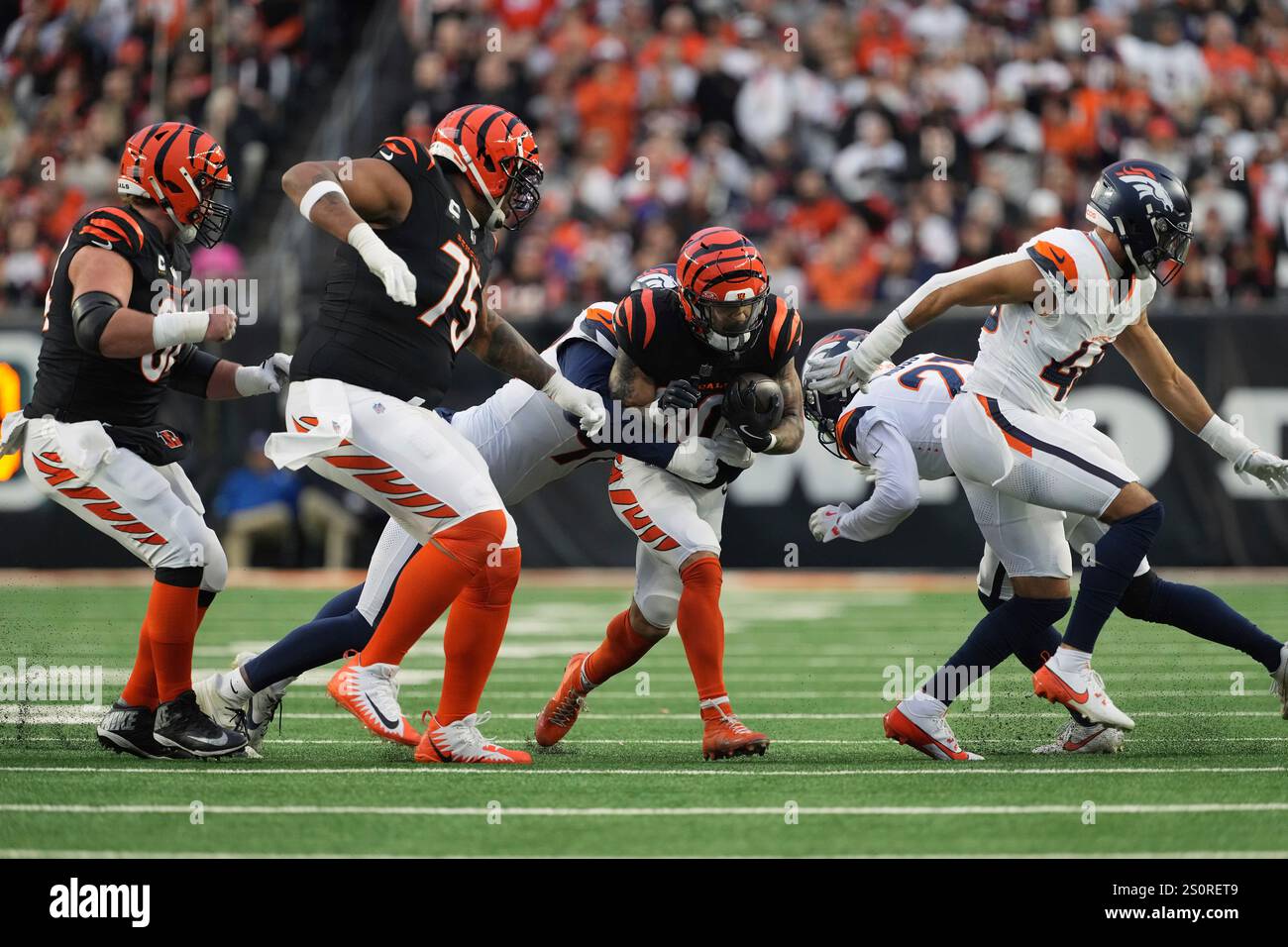 Cincinnati Bengals running back Chase Brown, center, carries the ball ...