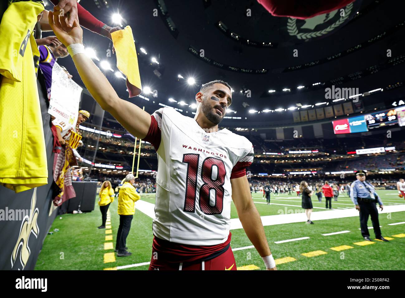 Washington Commanders quarterback Marcus Mariota (18) signs autographs ...