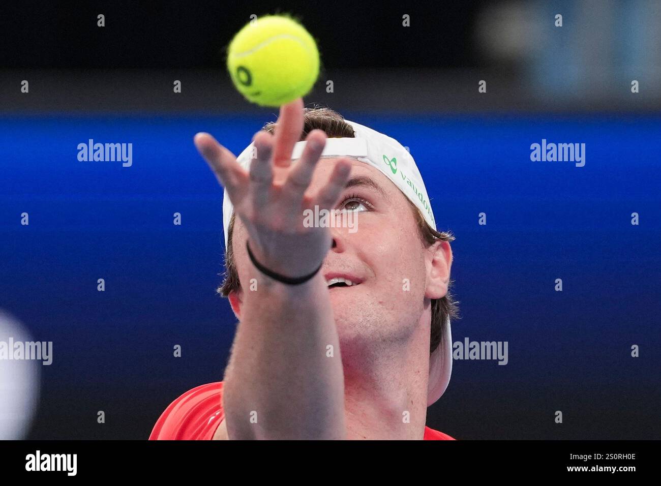 Switzerland's Dominic Stricker serves to Italy's Flavio Cobolli during ...