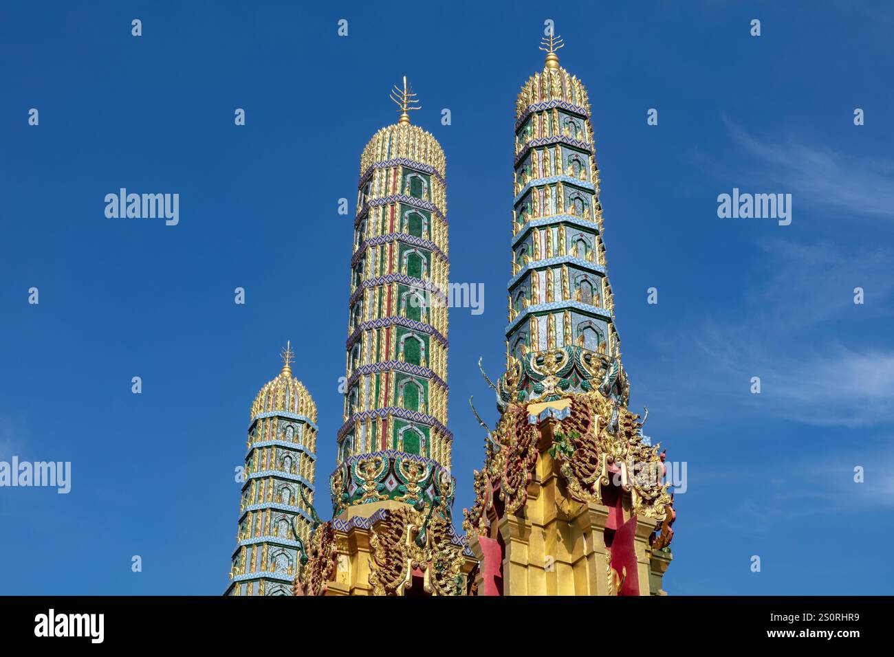 Three towering spires, ornately decorated, at the temple of Wat Khun ...
