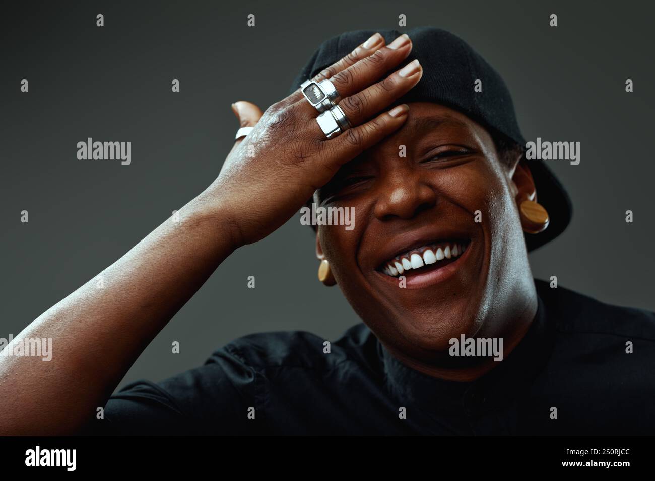 Studio portrait of a cheerful african american musician laughing with ...