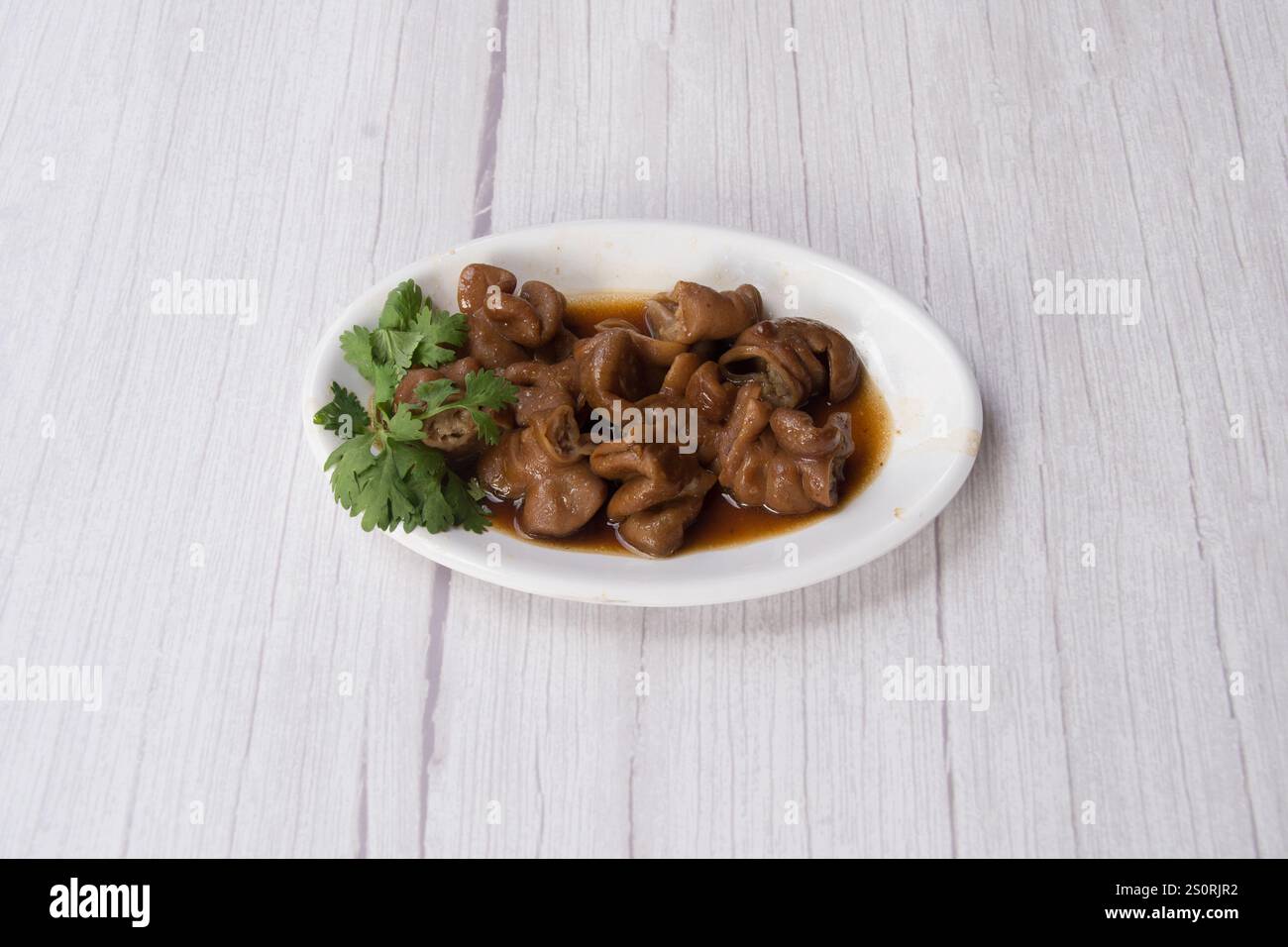 a dish of braised pig large intestines chopped and served up Stock ...