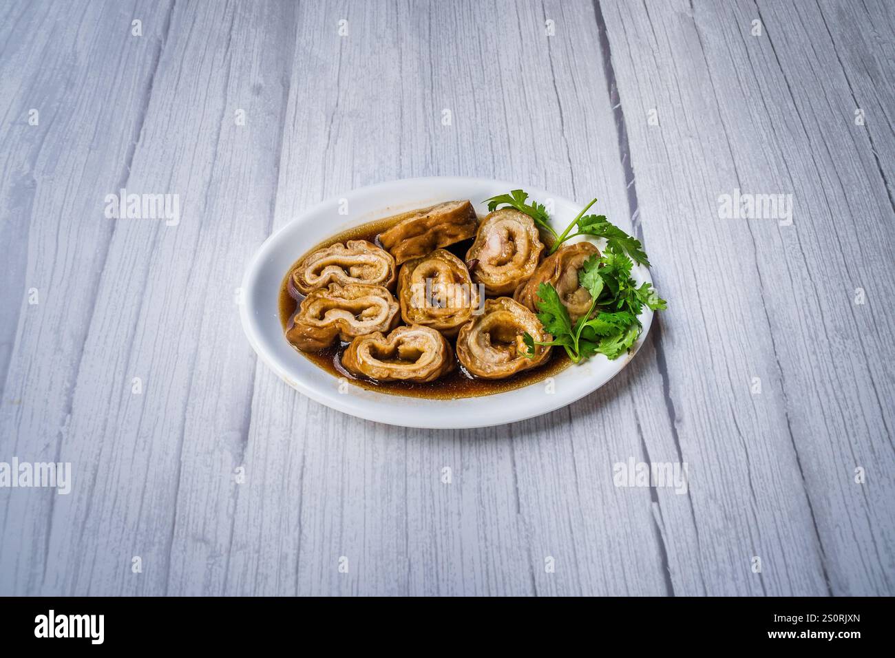 a dish of braised pig intestines chopped and served up Stock Photo - Alamy
