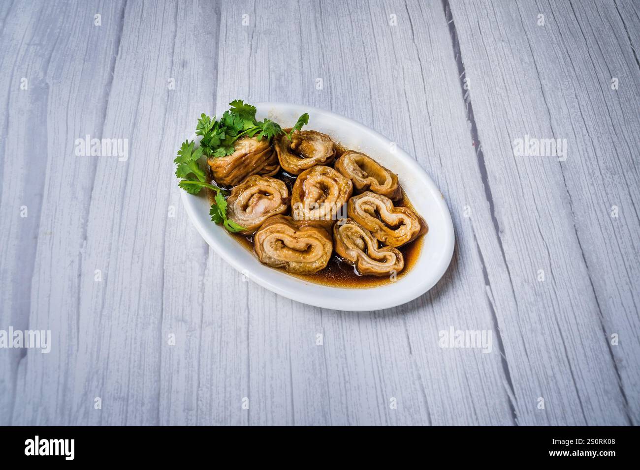a dish of braised pig intestines chopped and served up Stock Photo - Alamy