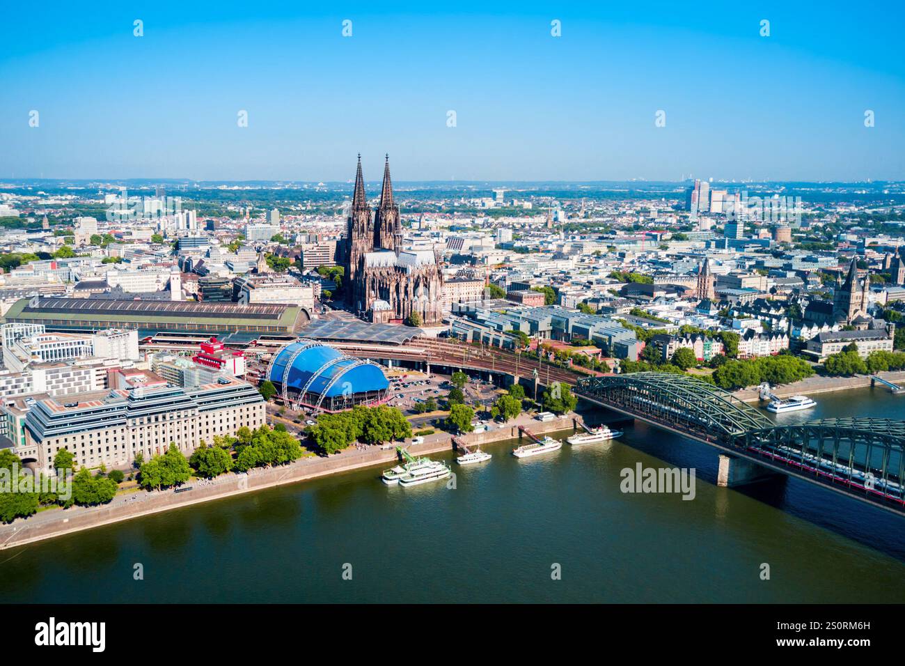 Cologne Cathedral and Hohenzollern Bridge through Rhine river aerial ...