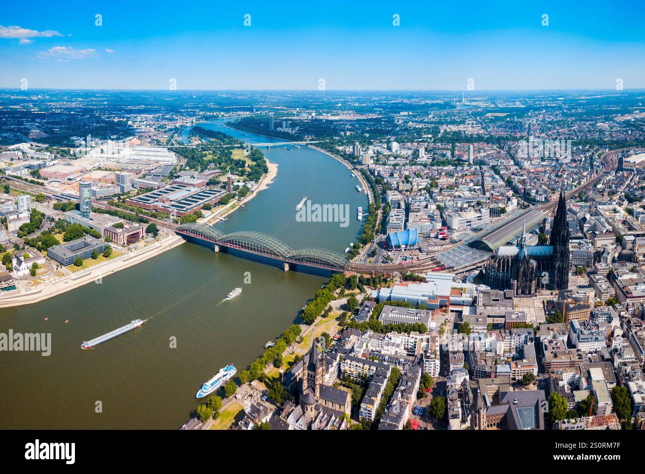 Cologne Cathedral and Hohenzollern Bridge through Rhine river in ...