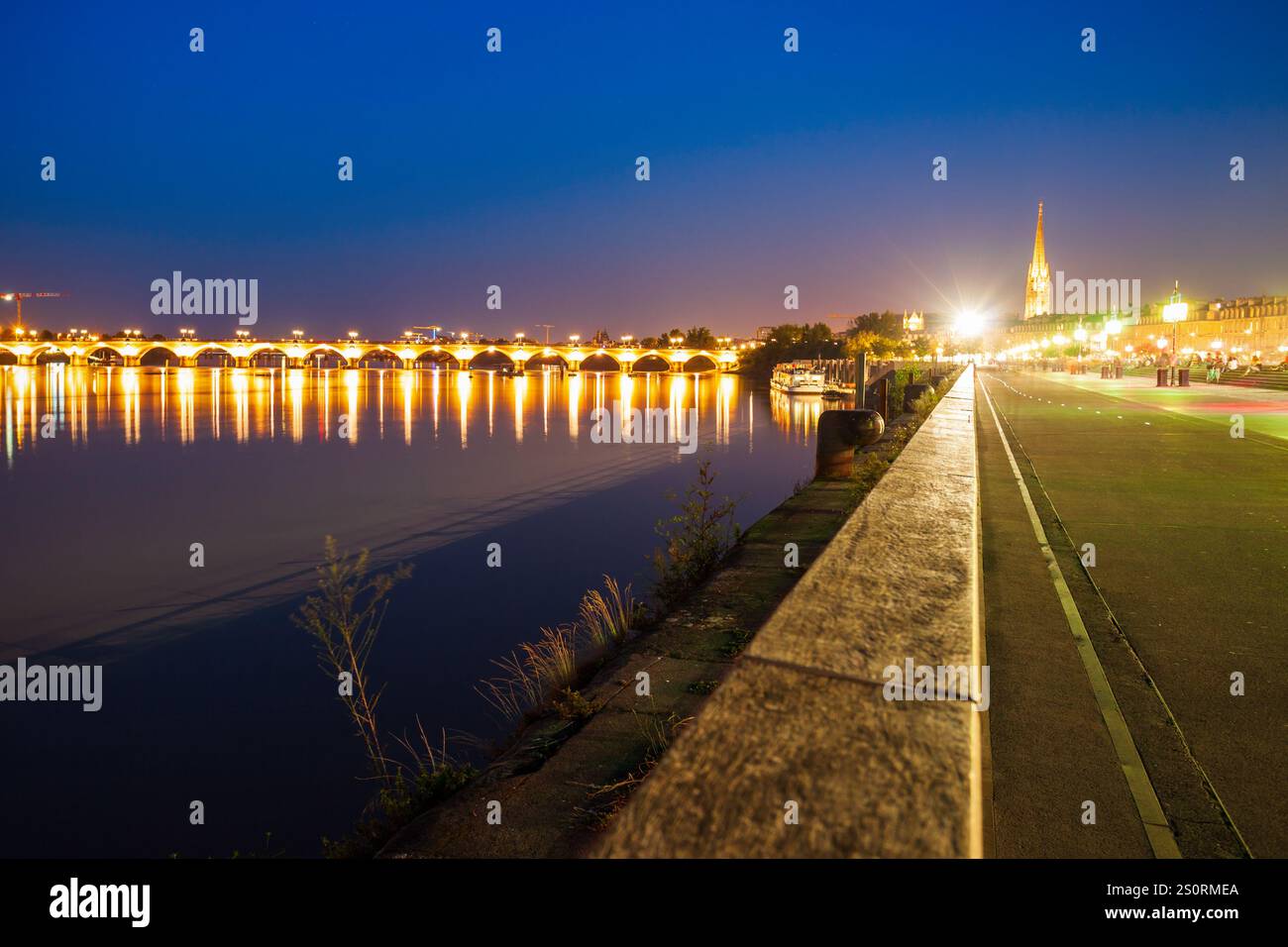 Pont de Pierre bridge in Bordeaux at night. Bordeaux is a port city on ...