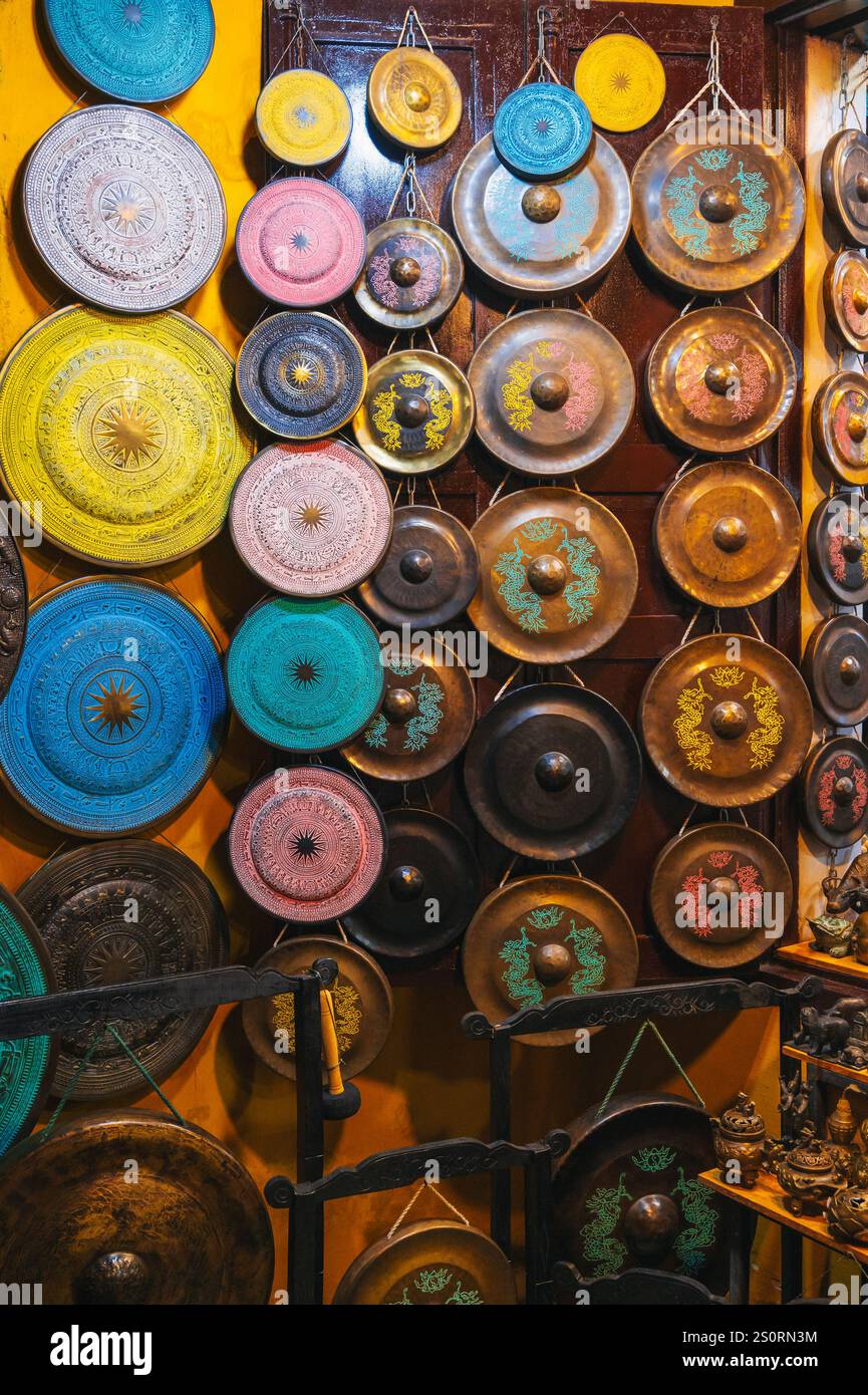 The gongs hanging on the wall are traditional Asian musical instruments ...