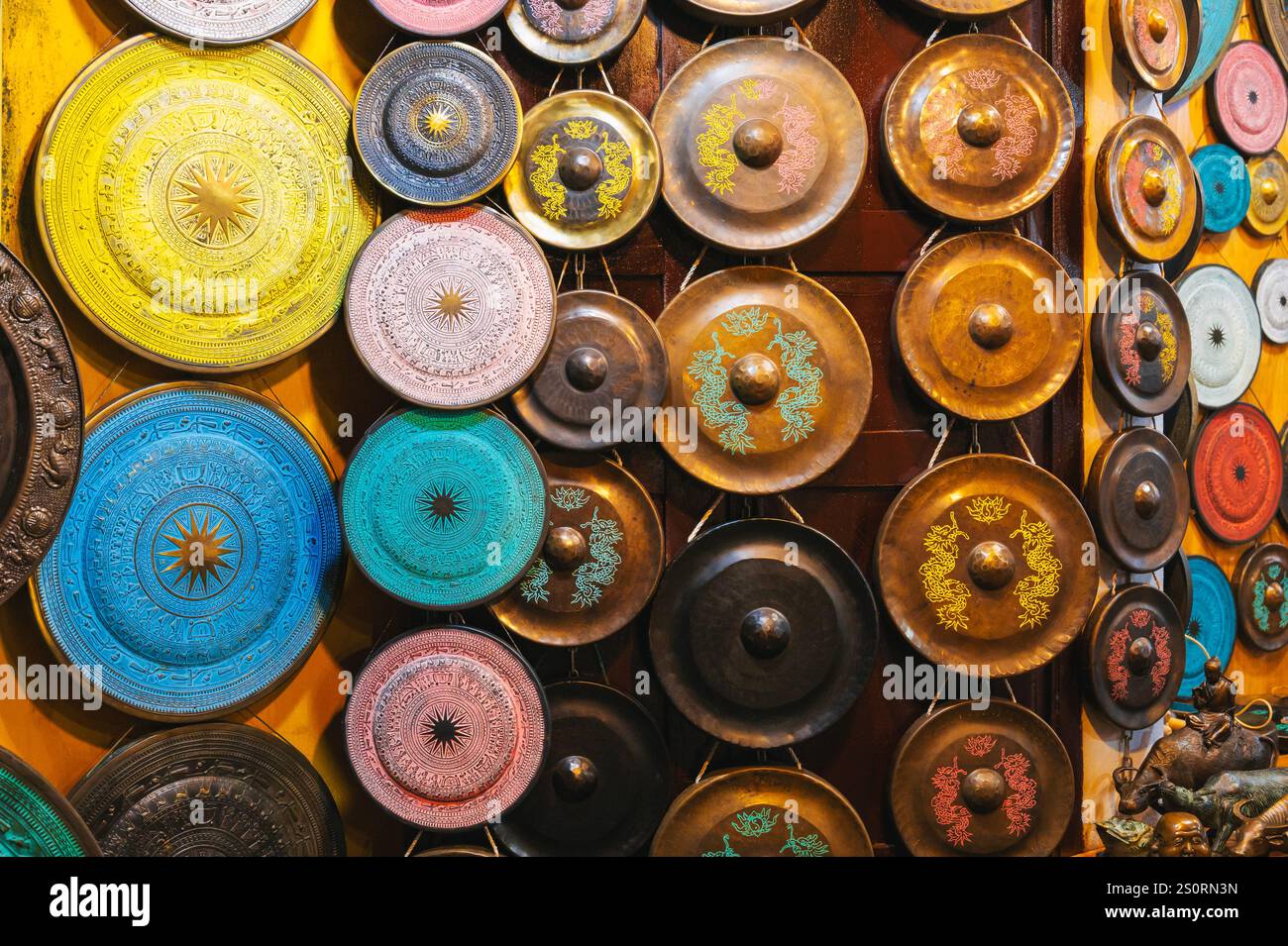 The gongs hanging on the wall are traditional Asian musical instruments ...