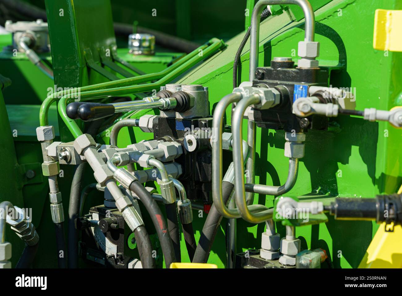 Intricate hydraulic components are interconnected in a green machinery ...