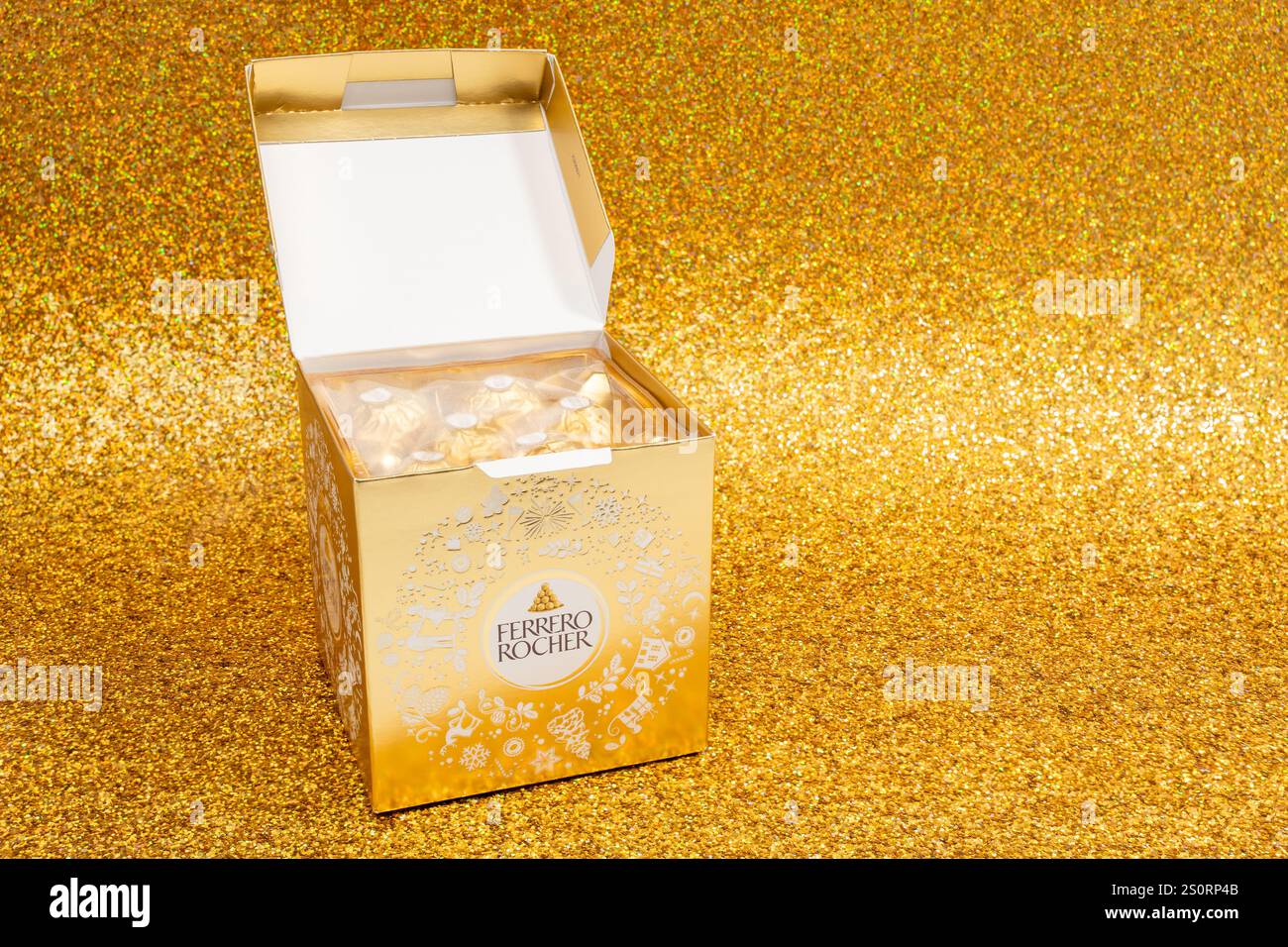 Gold box of chocolates with a ribbon at the top with the inscription ...