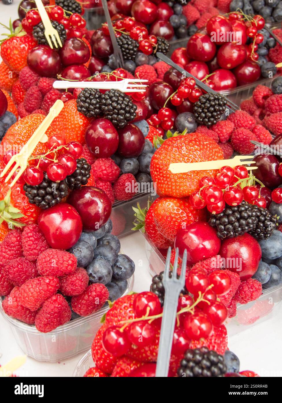 assorted ripe forest fruits and other berries in ready to ear portions ...