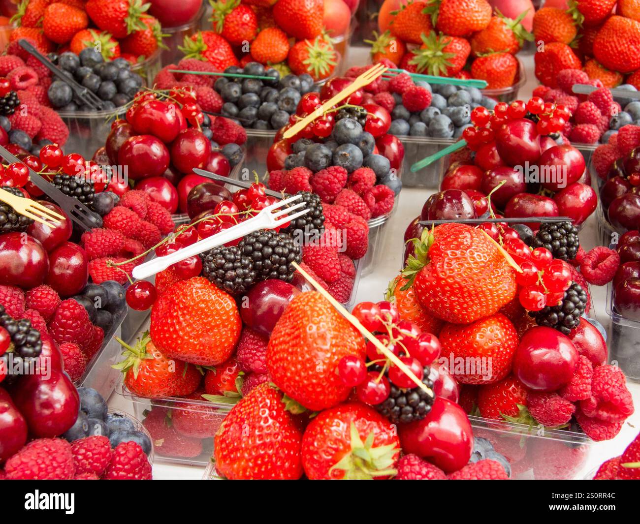 assorted ripe forest fruits and other berries in ready to ear portions ...