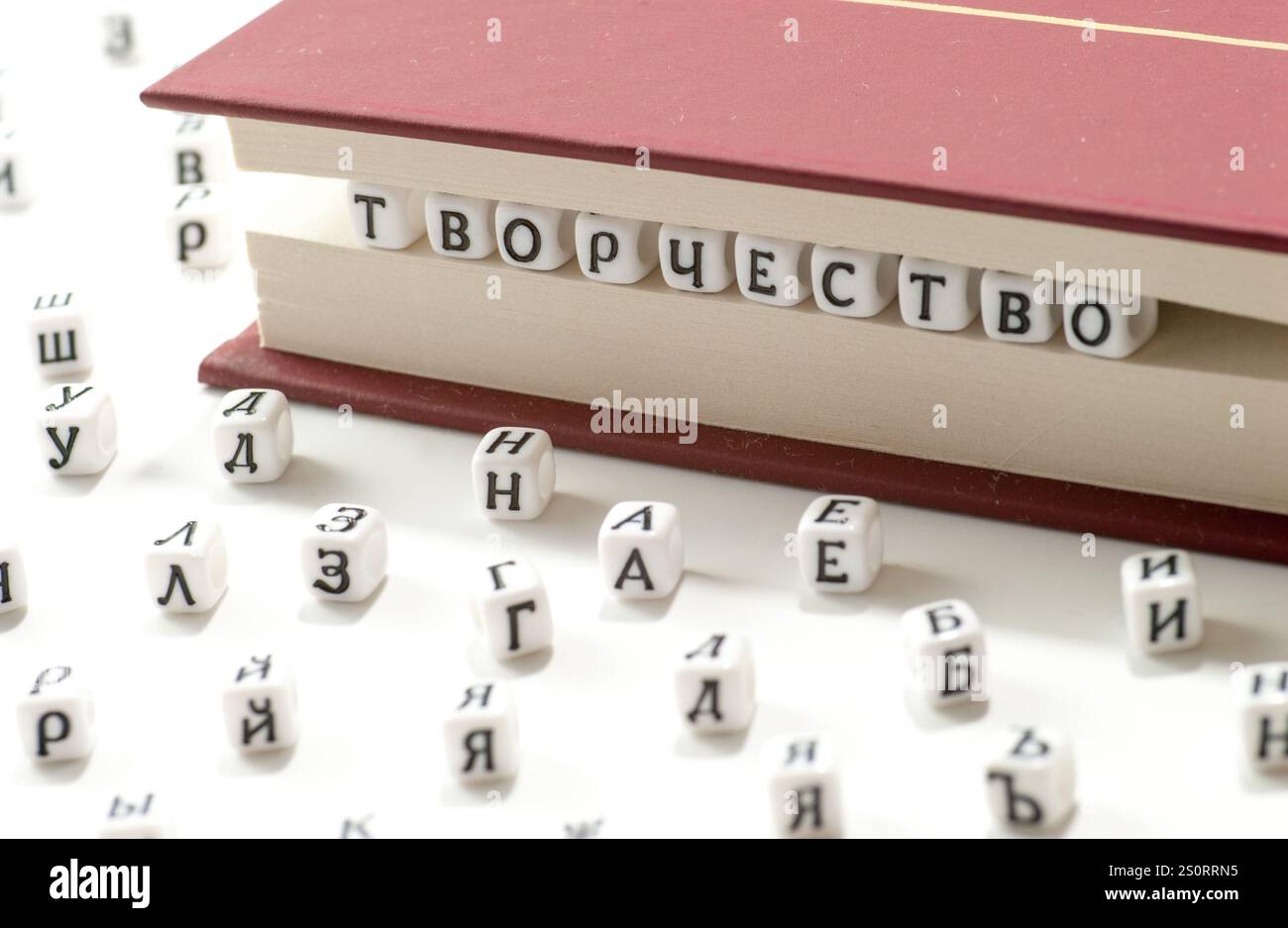 word creativity written win cyrillic letters between book sheets and ...