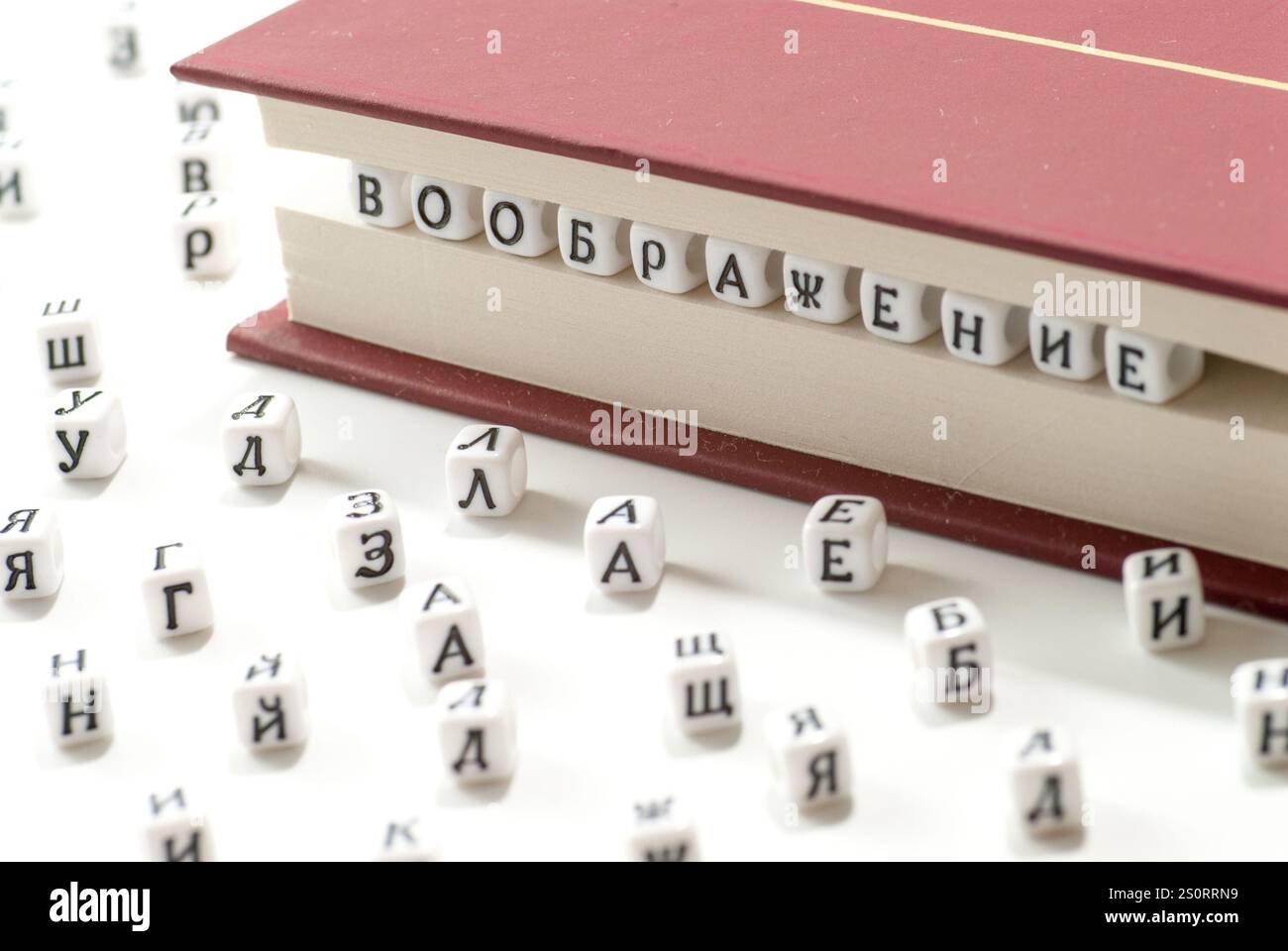 word imagination written win cyrillic letters between book sheets and ...