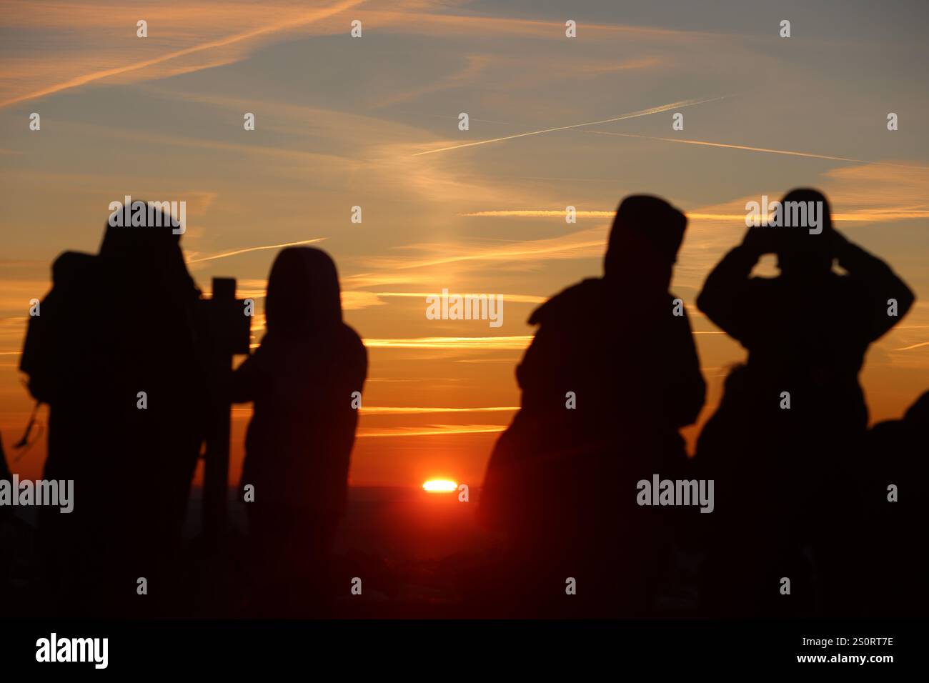 29 December 2024, Saxony-Anhalt, Schierke: Hikers stand on the Brocken ...