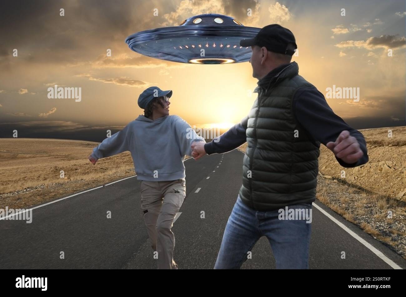 Married couple runs away along the road from UFO flying behind them ...