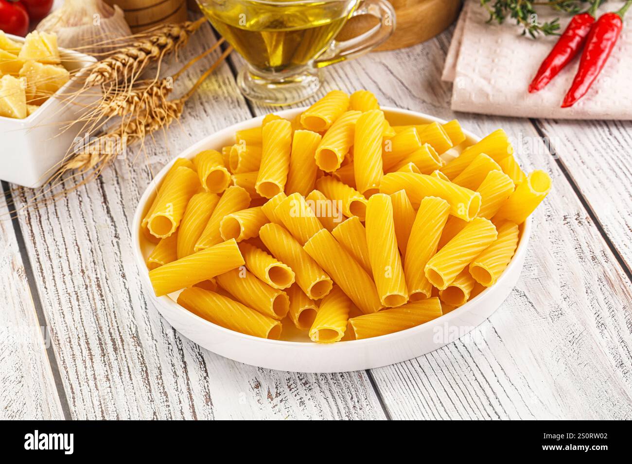 Italian cuisine - raw dry tortiglioni pasta Stock Photo - Alamy
